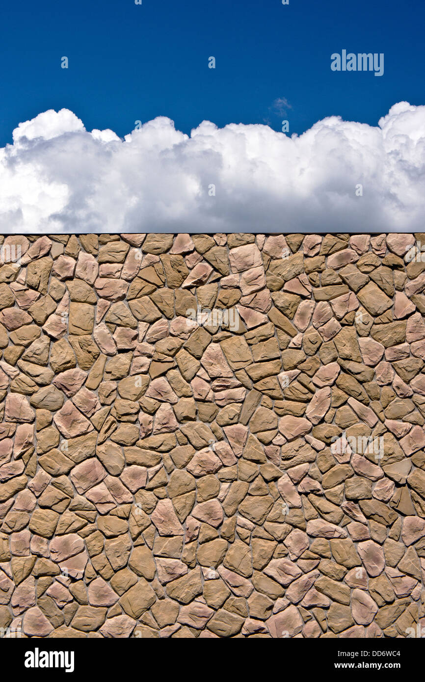 Stone wall and blue sky with clouds Stock Photo - Alamy