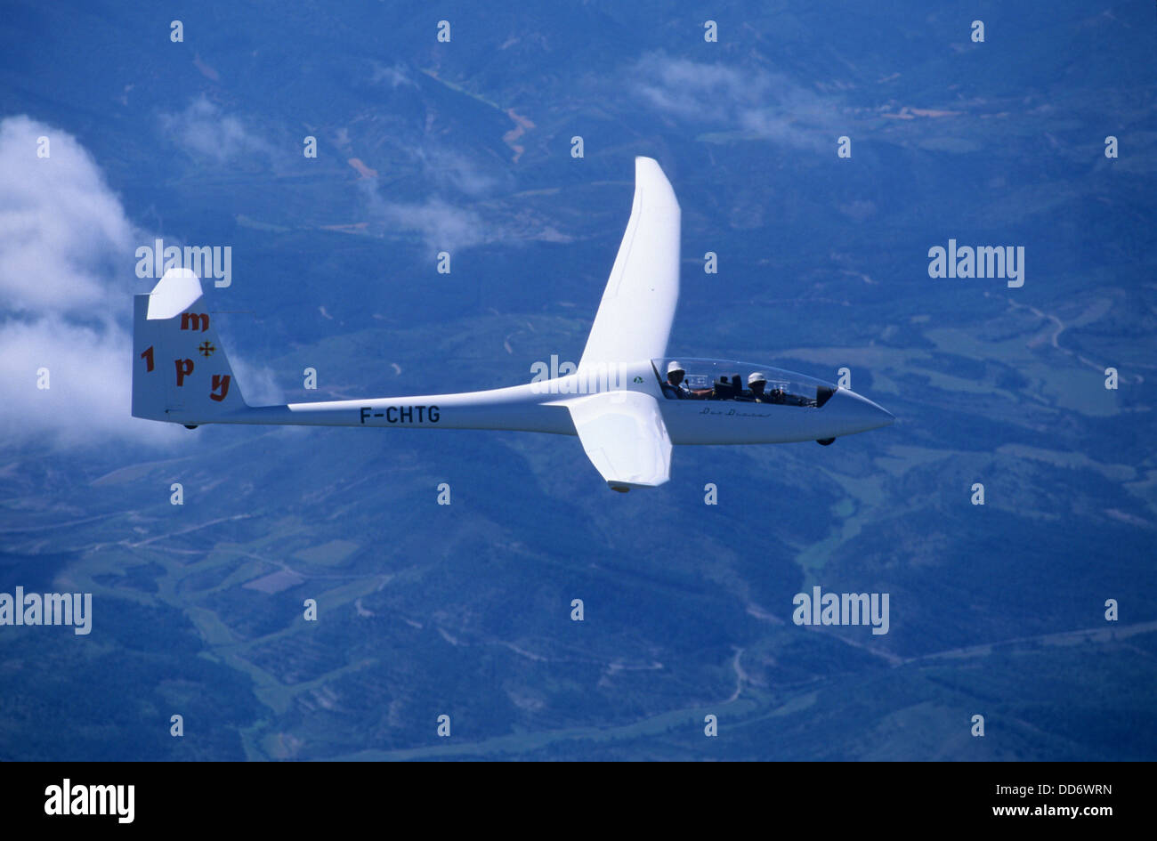 Glider plane Duo Discus flying over clouds near Jaca, Aragon, Spain ...