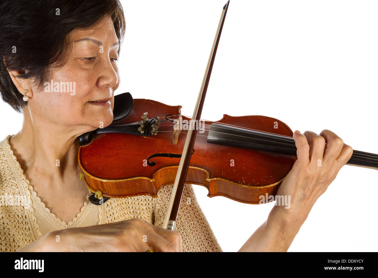 Closeup horizontal photo of a senior woman playing the violin on white ...