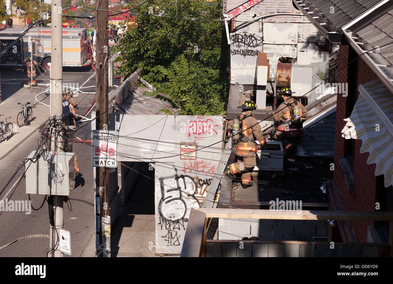 Toronto firefighters navigate a derelict building rooftop to help ...