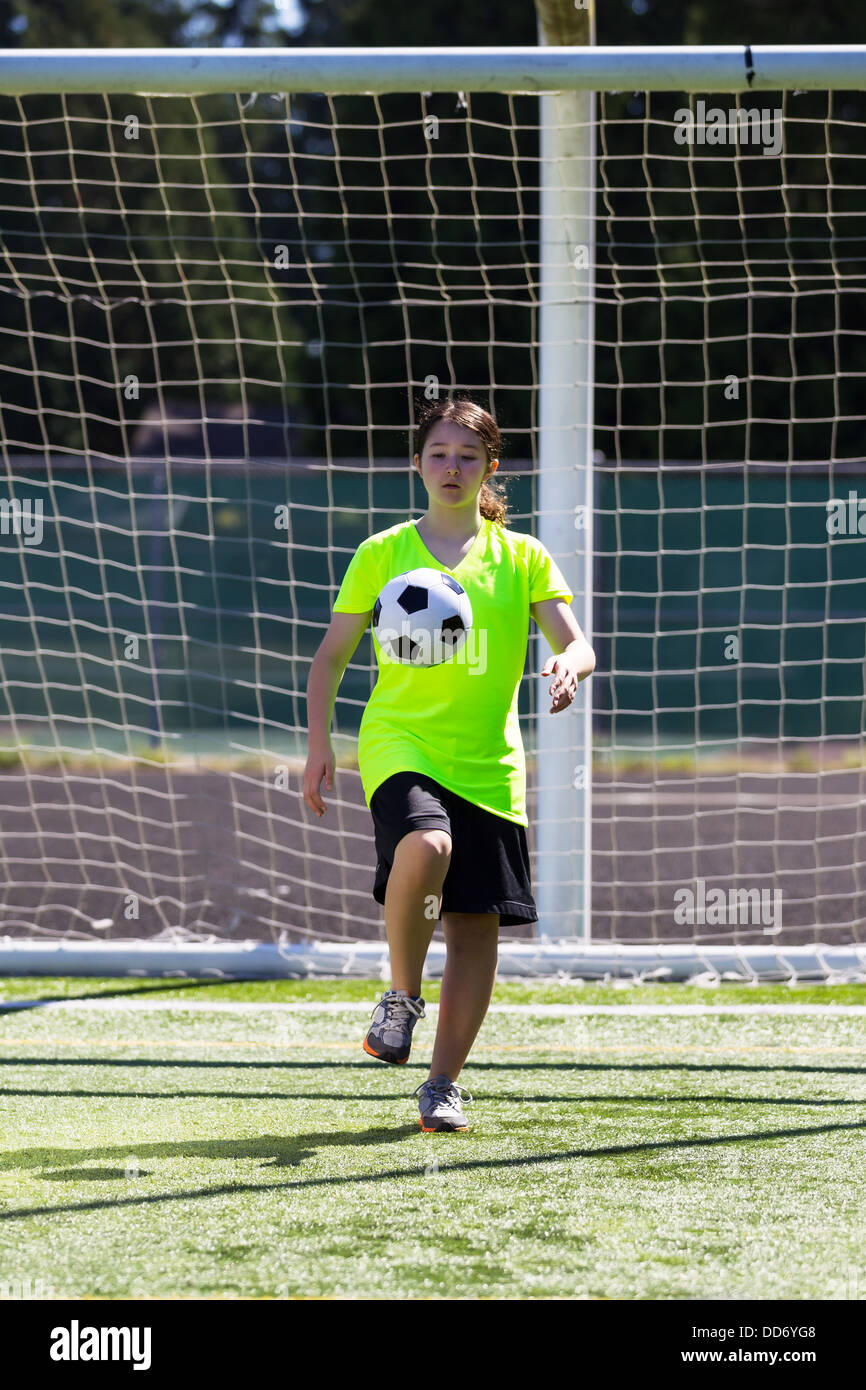 Girl kicking ball hi-res stock photography and images - Alamy
