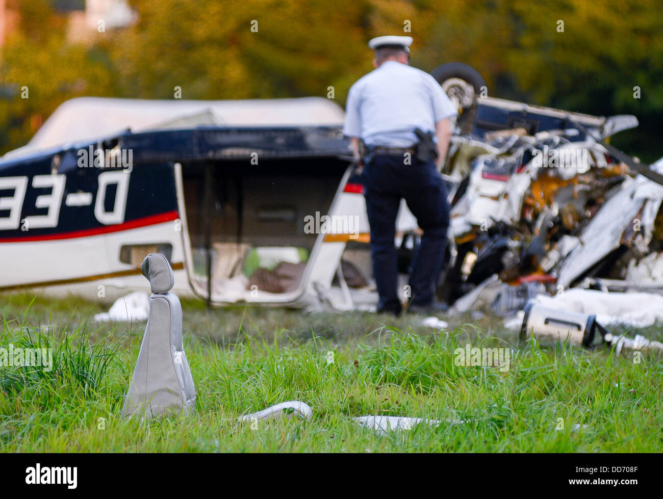 A police officer looks at the wreck of an airplane near Froendenberg ...