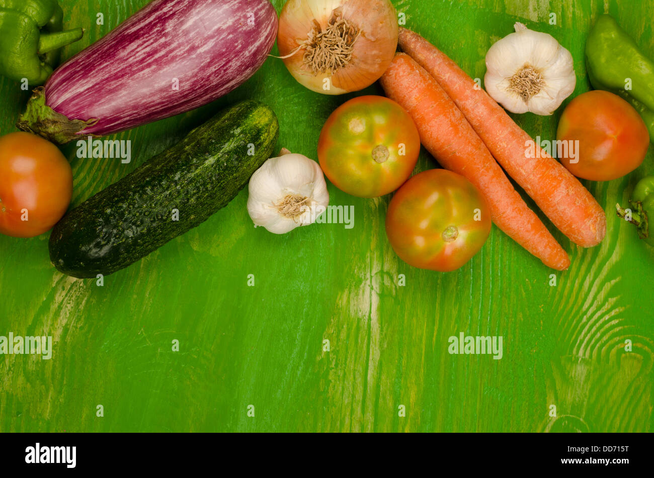 Fresh vegetables arranged on a rustic green table Stock Photo - Alamy