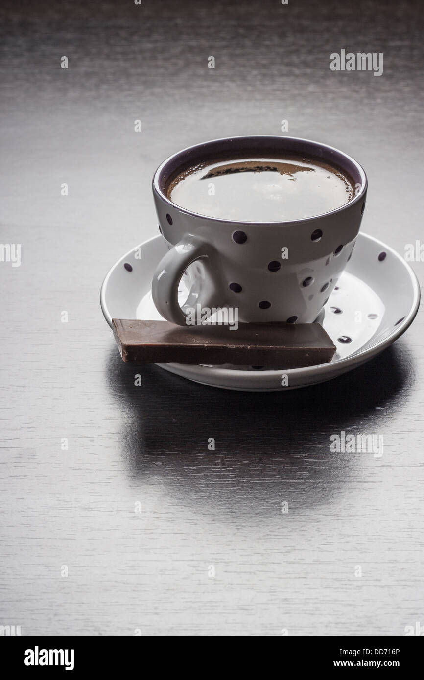coffee cup and chocolate on wooden table Stock Photo - Alamy