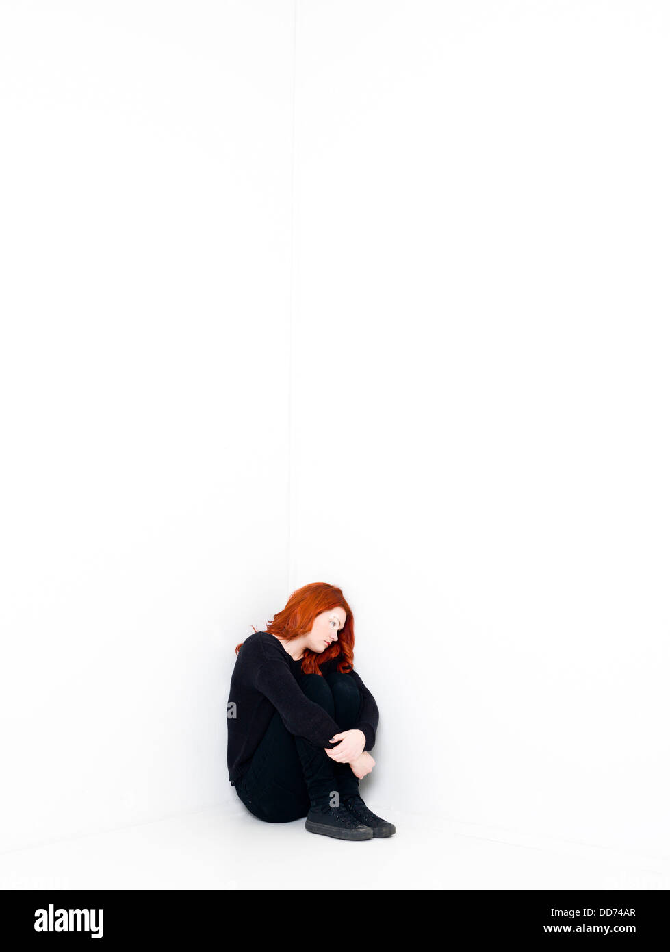 Sad woman standing wall Cut Out Stock Images & Pictures - Alamy