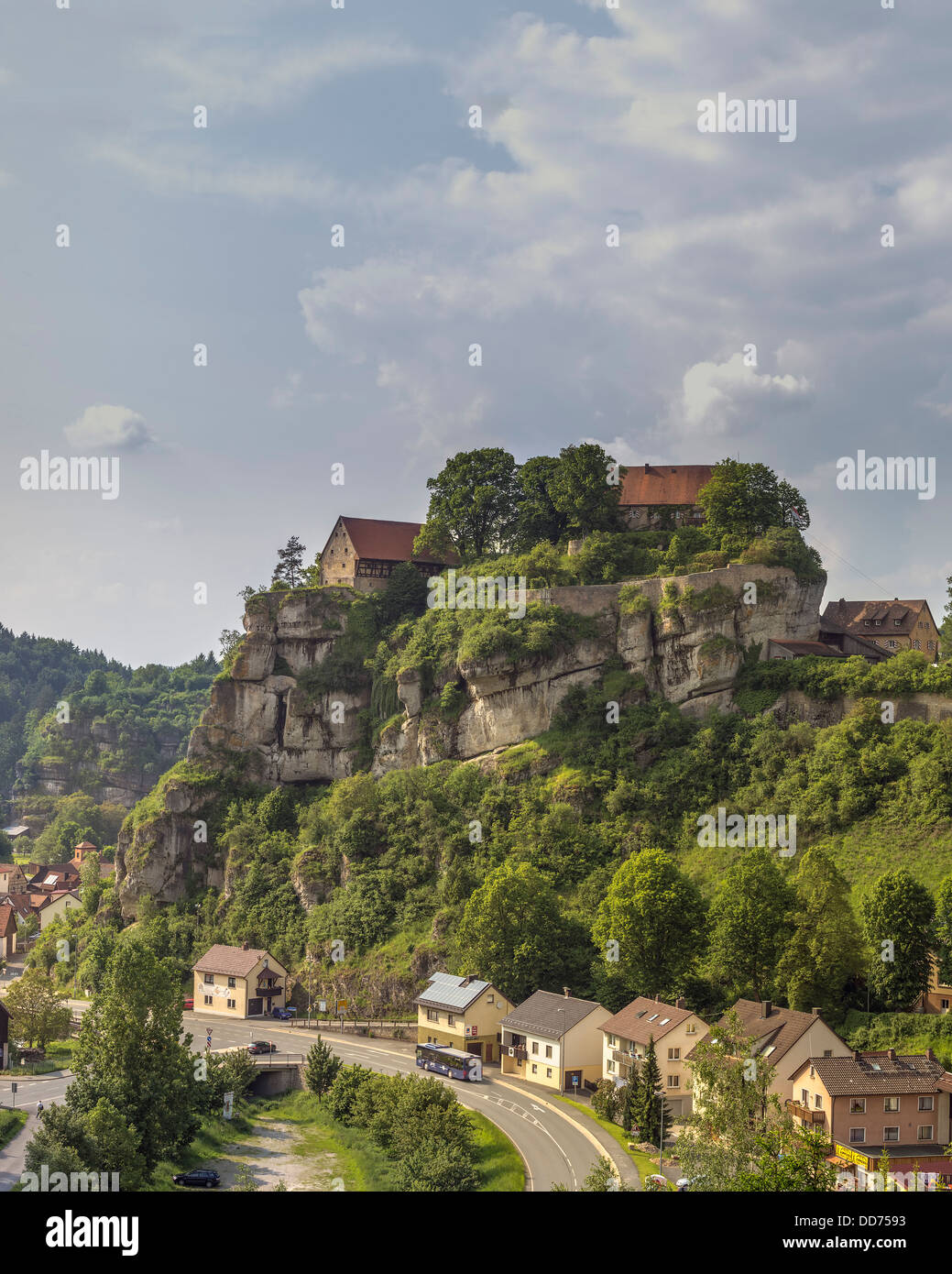 Germany, Bavaria, Pottenstein castle on top of mountain with town in ...
