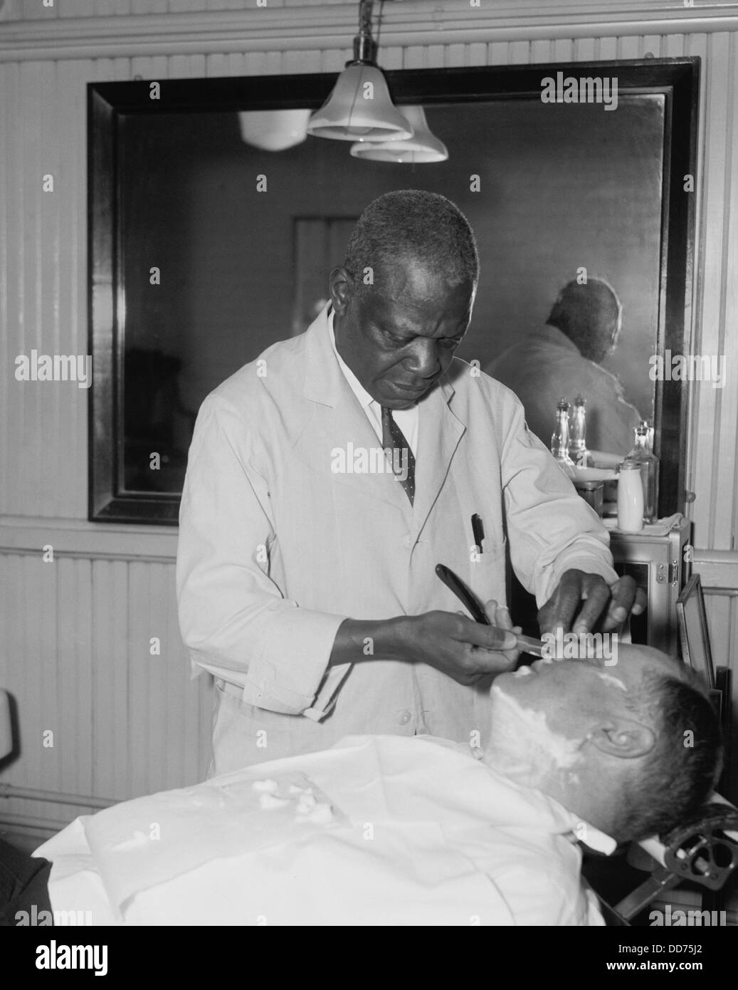 African American barber at the Senate Barbershop. Jan. 5, 1937. Senator ...