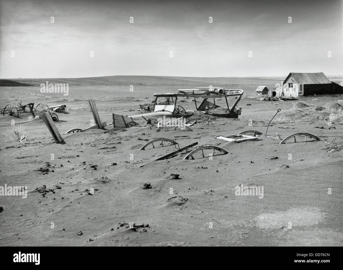 Buried machinery in a barn lot in Dallas, South Dakota in 1936. The ...