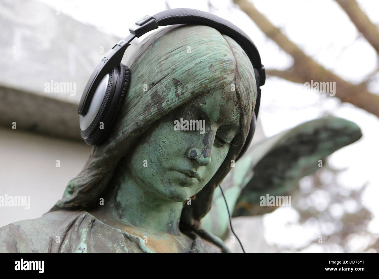 Germany, Cologne, Angel statue with headphones in cemetery Stock Photo ...