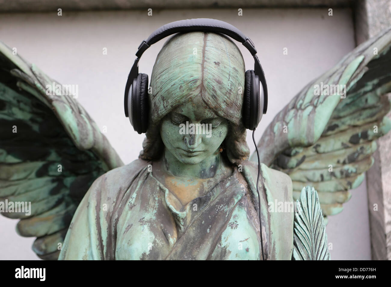 Germany, Cologne, Angel statue with headphones in cemetery Stock Photo ...
