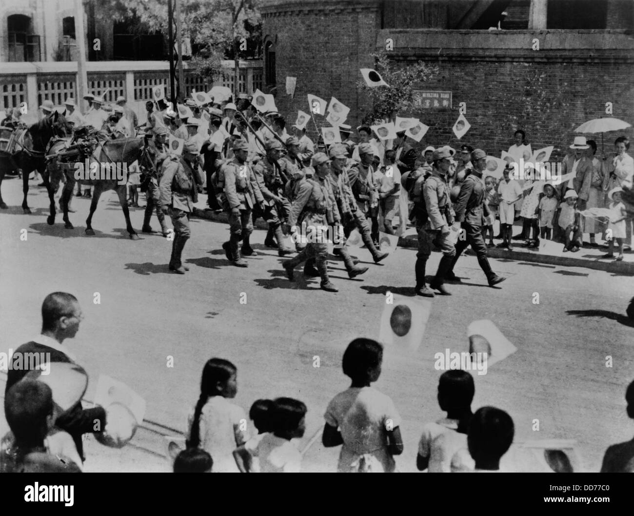 Japanese residents of Beijing, China, welcome Japanese invaders. Men ...