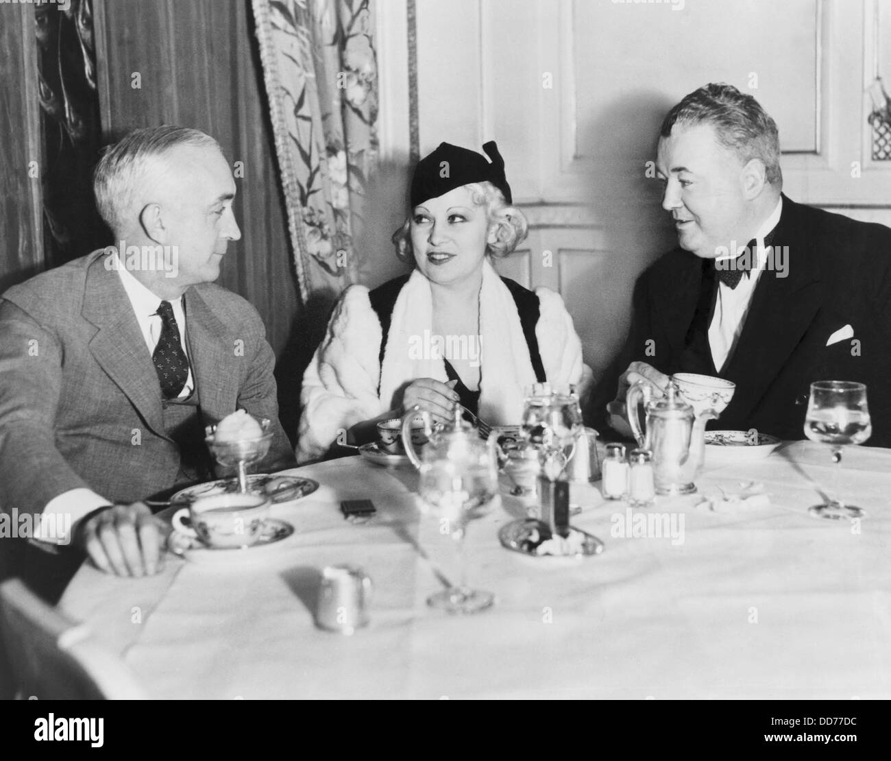 Mae West dining at the Victor Hugo Café with her manager James Timony ...