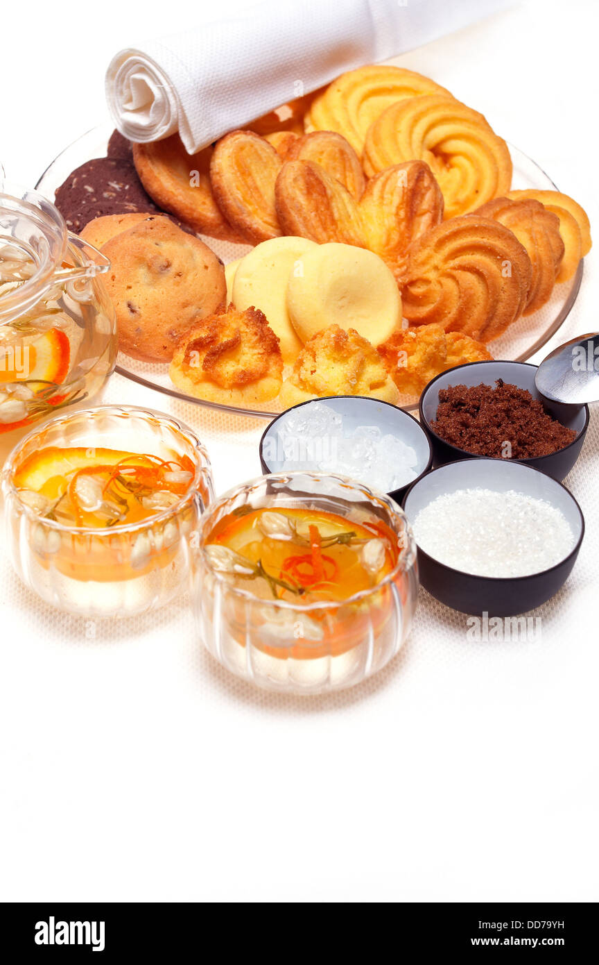 floral tea set and pastry assortment over white Stock Photo - Alamy