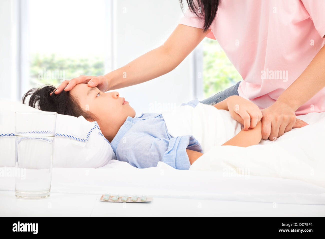 Mother checking temperature of sick daughter by hand Stock Photo - Alamy