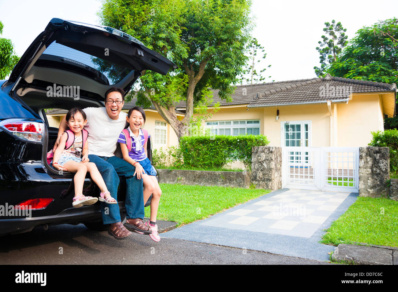 happy family sitting in the car and their house behind Stock Photo - Alamy