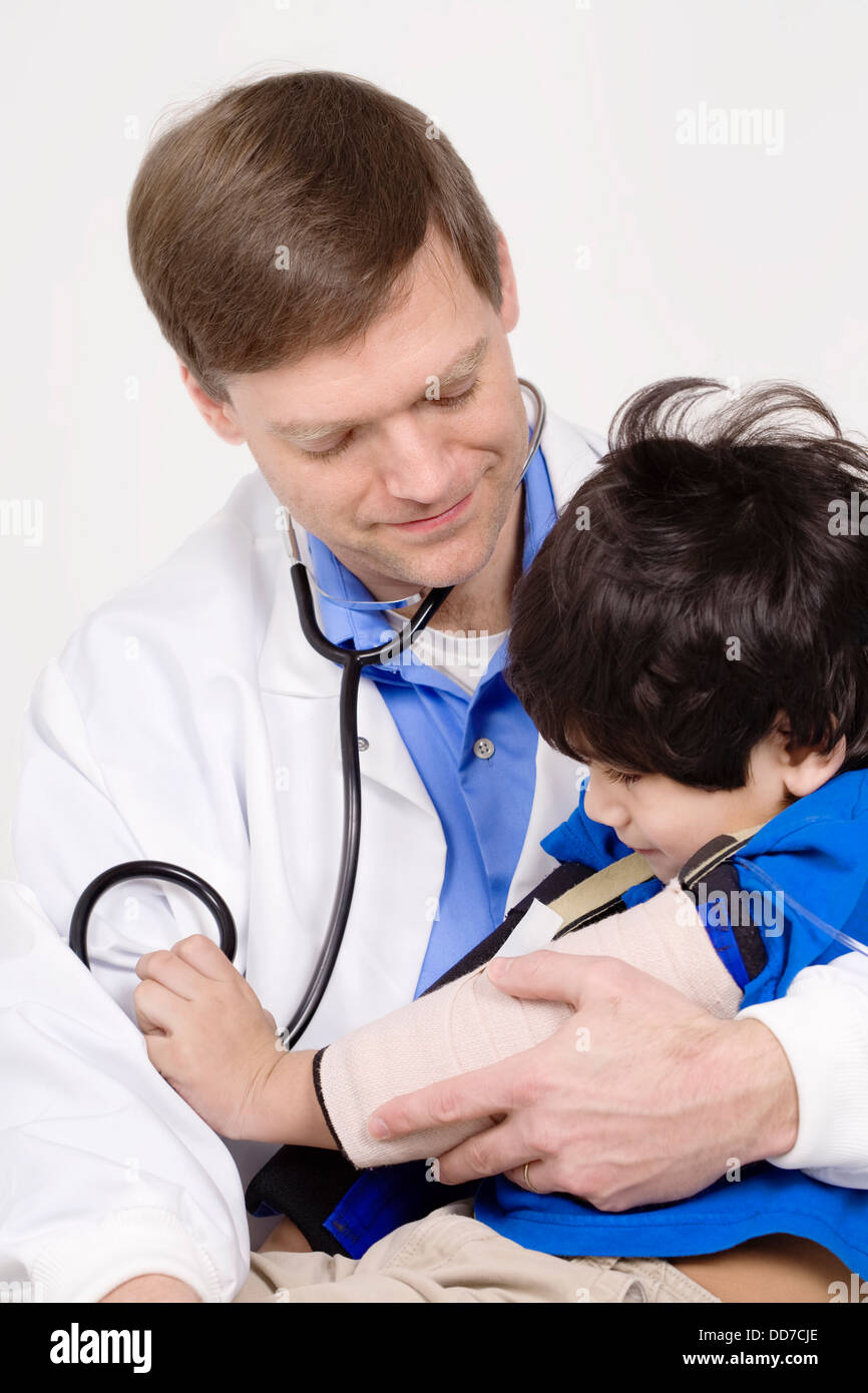 Male doctor interacting with disabled toddler patient on lap Stock ...