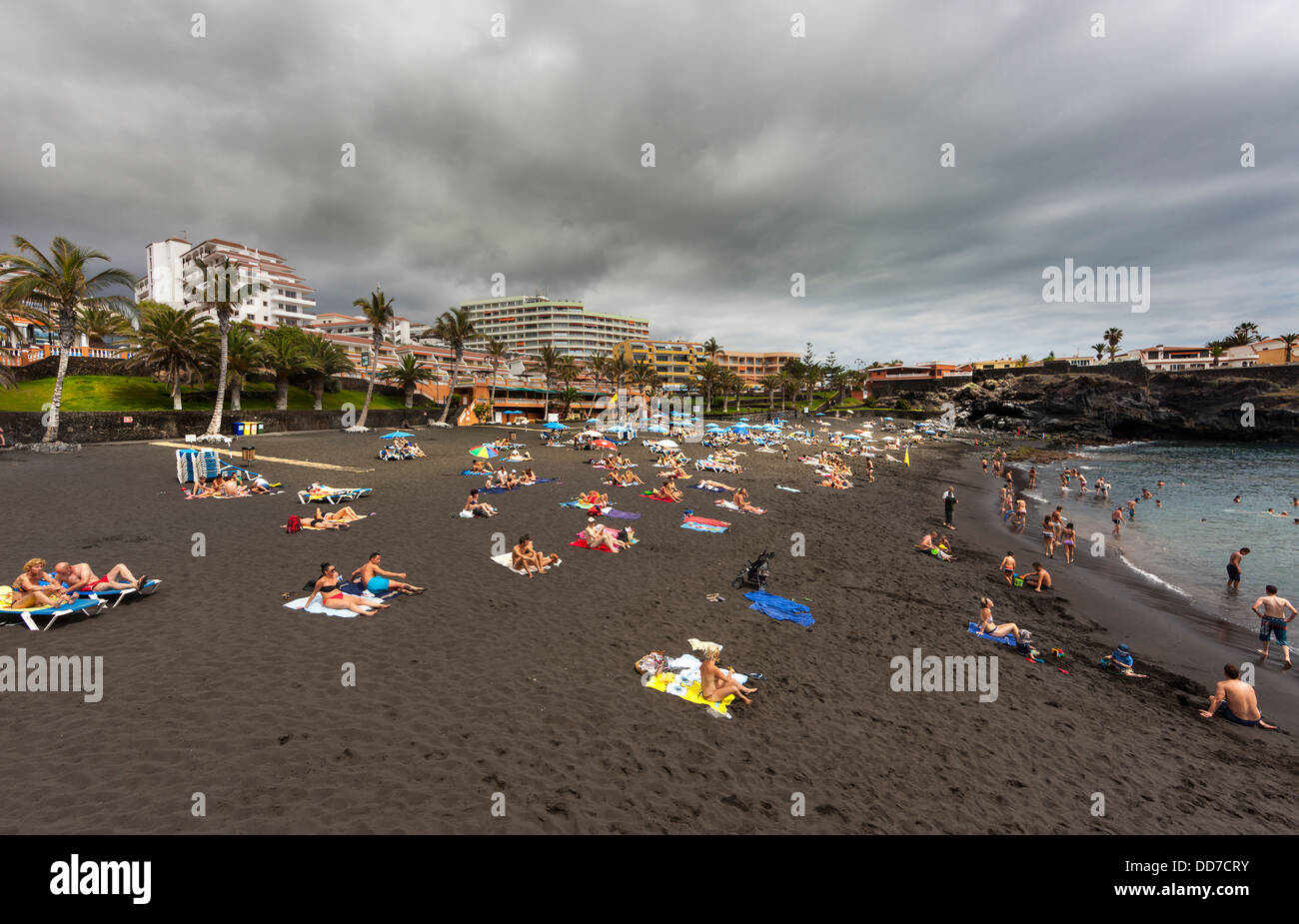 Spain, People relaxing at black sand beach Stock Photo - Alamy