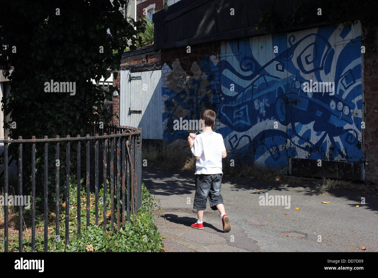 boy passing graffiti Stock Photo - Alamy