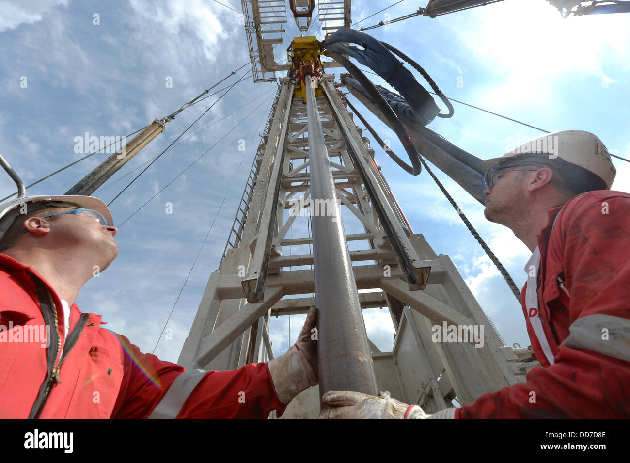 Crumstadt, Germany. 28th Aug, 2013. Two workers stand on the work ...