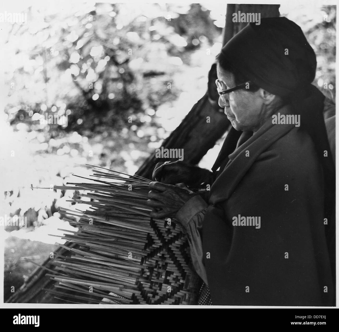 Elderly native american woman weaving a basket at oconaluftee village ...