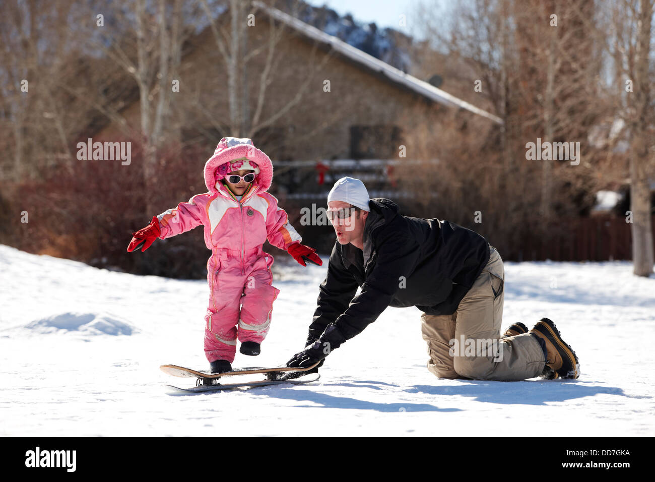 Father and daughter playing in snow Stock Photo - Alamy