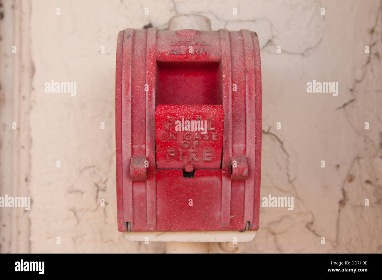 Vintage red wall fire alarm on stucco wall Stock Photo - Alamy
