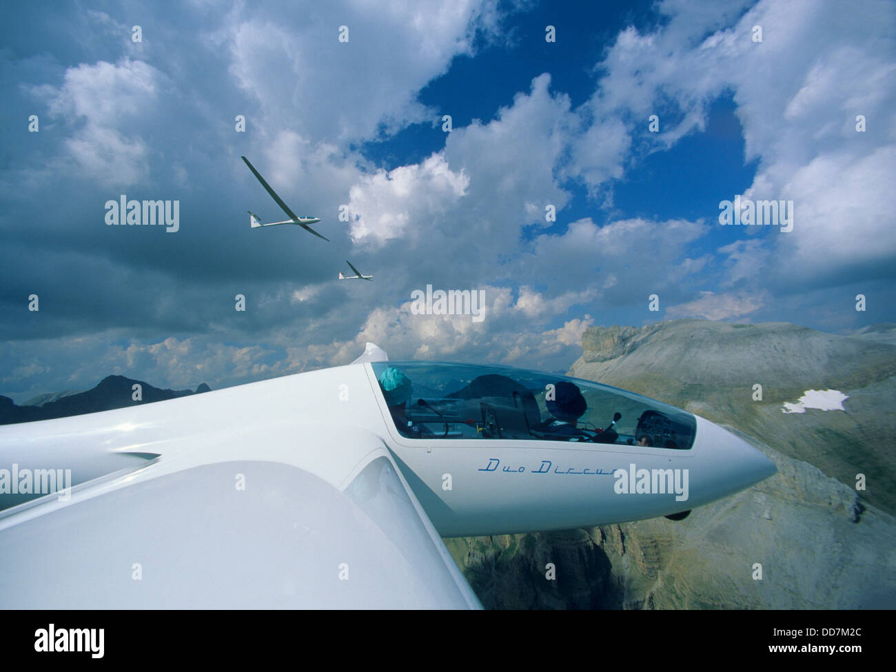 Glider plane Duo Discus flying with two others over Pyrenees mountains ...
