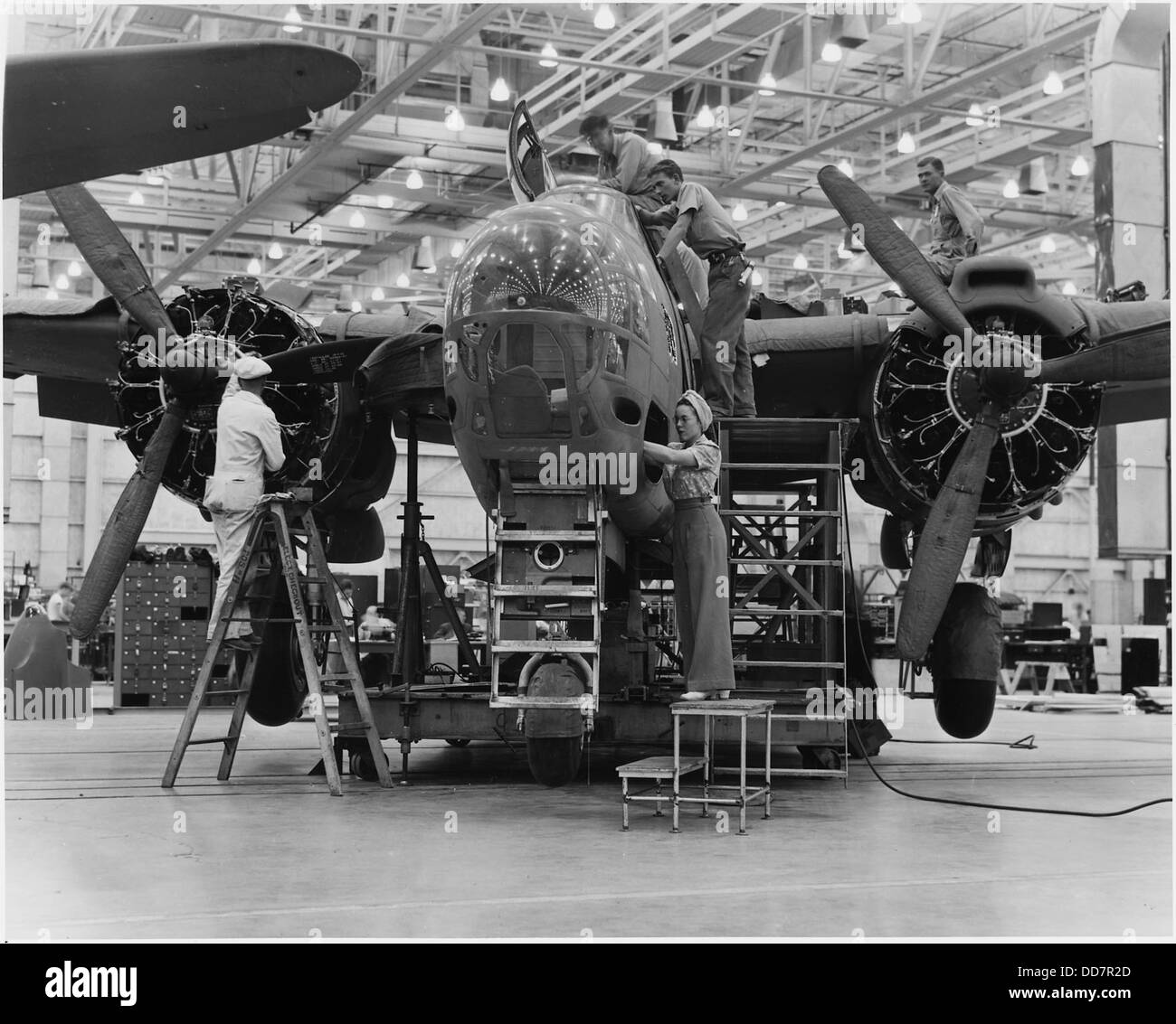 Experienced assembly line workers of both sexes contribute to the ...