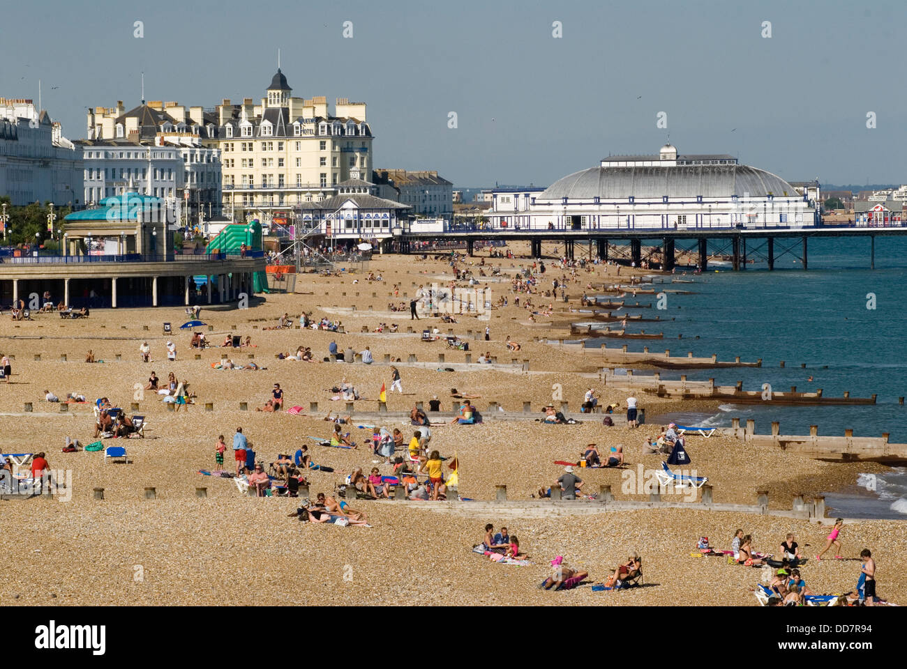 Eastbourne beach and pier summer sunny weather holiday crowds of people ...