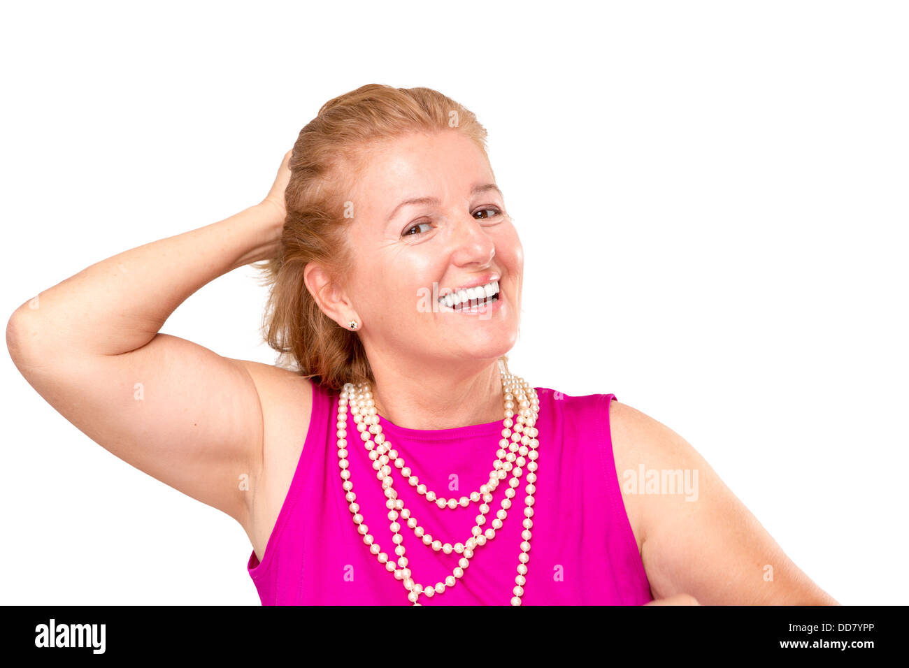 A blonde lady pulling her hair backwards with a great smile on her face ...