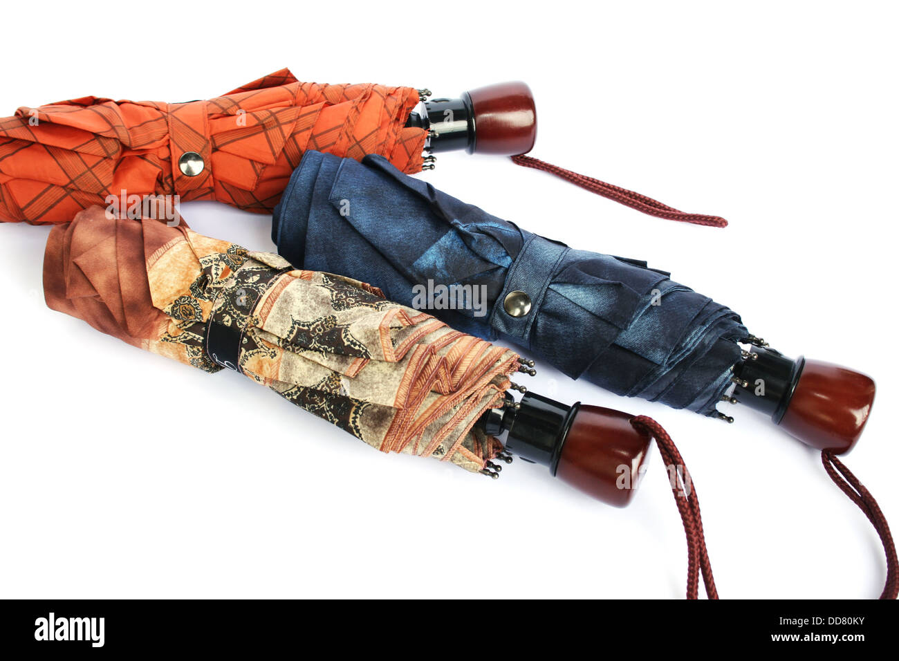 Three closed umbrellas isolated on white background Stock Photo - Alamy