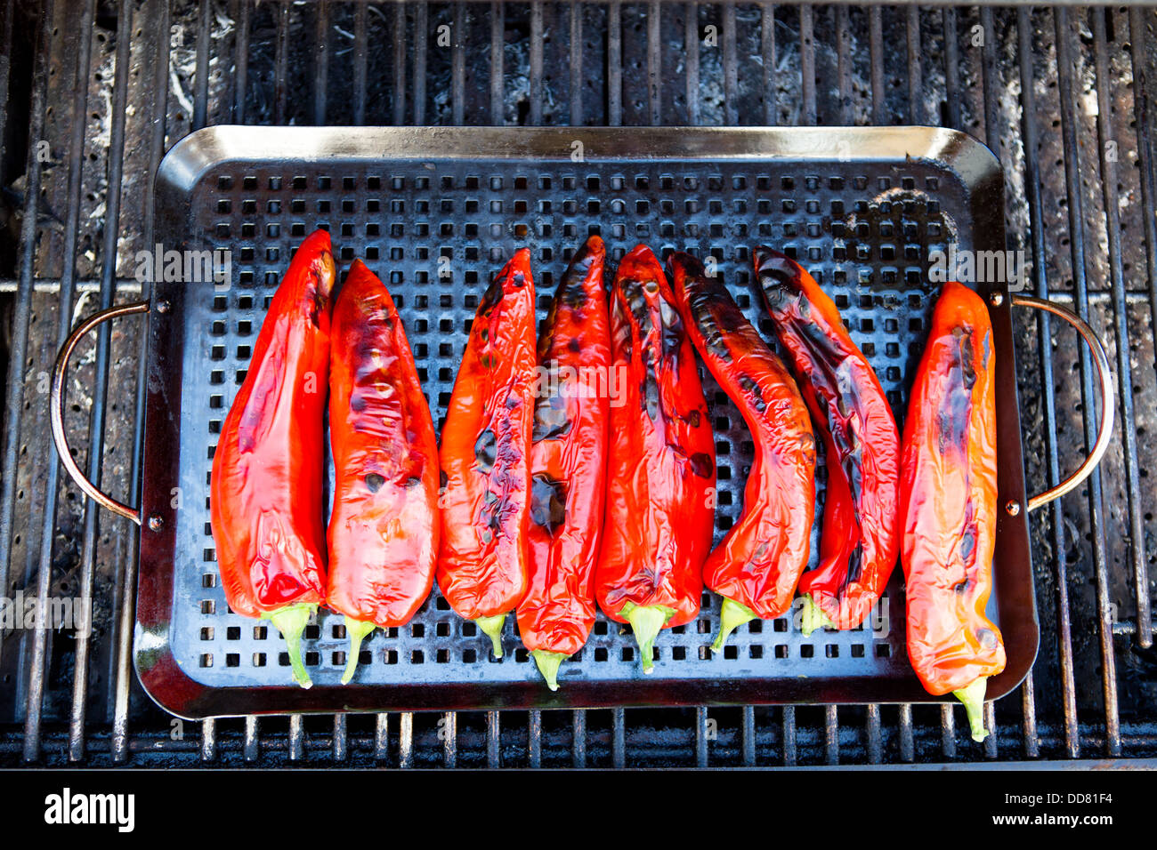 Eight pieces of grilled chili placed on a rectangular tray in the ...