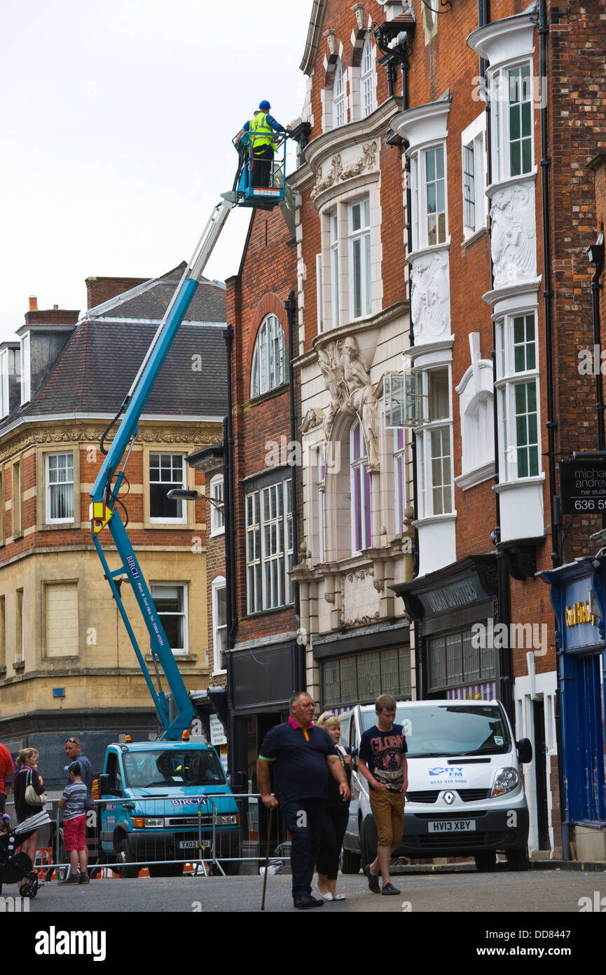 Contractors on high access platform making safe a building after being ...