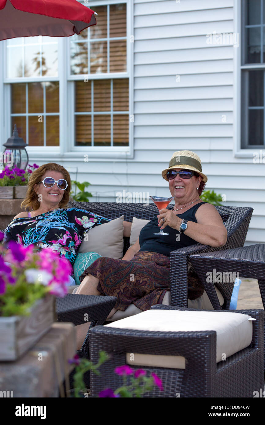 Couple women having happy conversations outside at the patio Stock ...