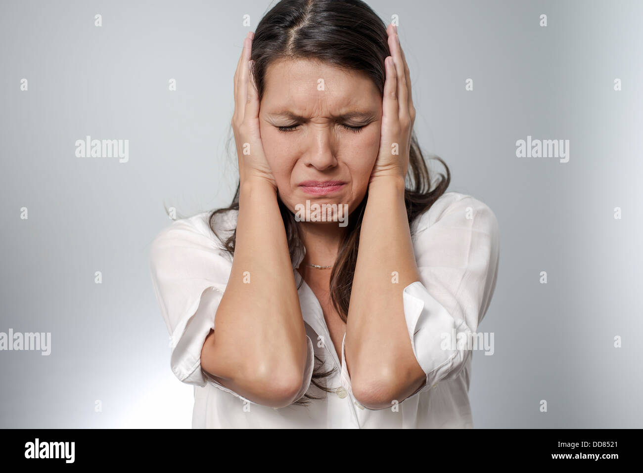 woman with headache and negative face expression - burn-out, depression ...