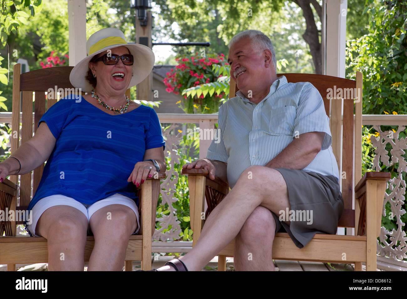 Retired couple having fun conversations. Woman is laughing while her ...