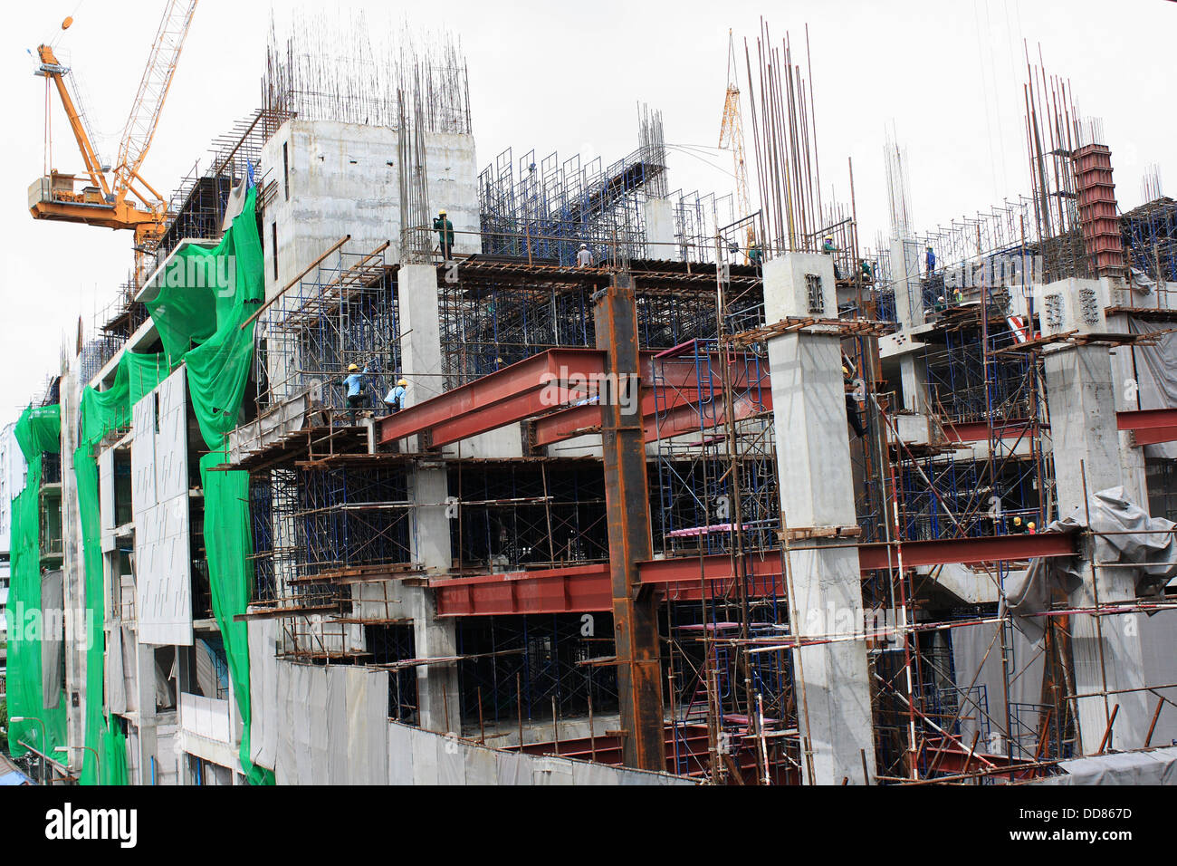 Construction a building in urban by man and machine Stock Photo - Alamy