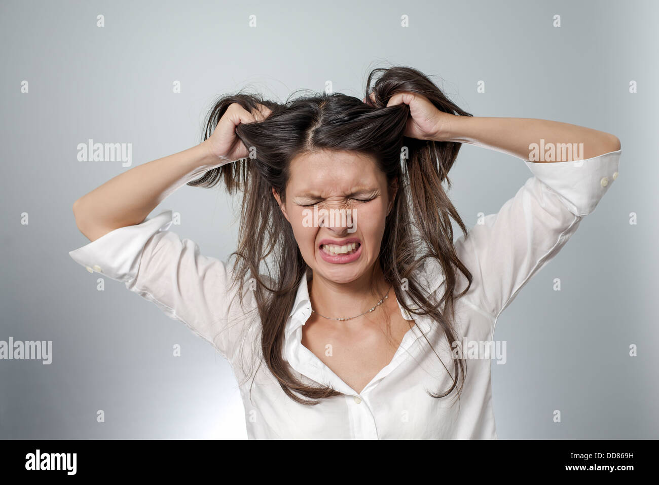 woman with headache and negative face expression - burn-out, depression ...