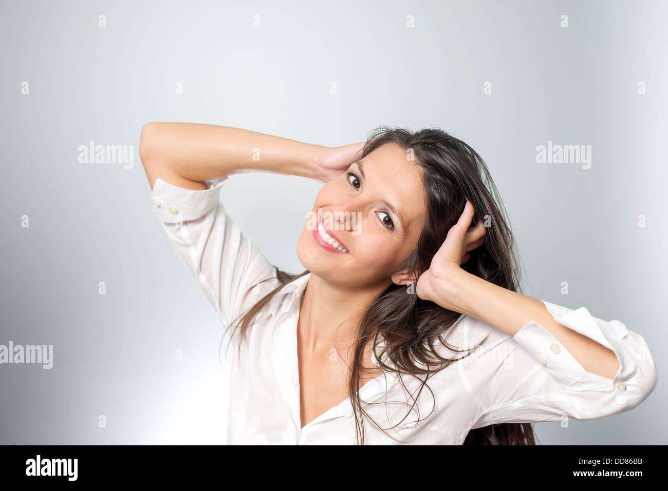 portrait of attractive brunette woman tilting her head to one side ...