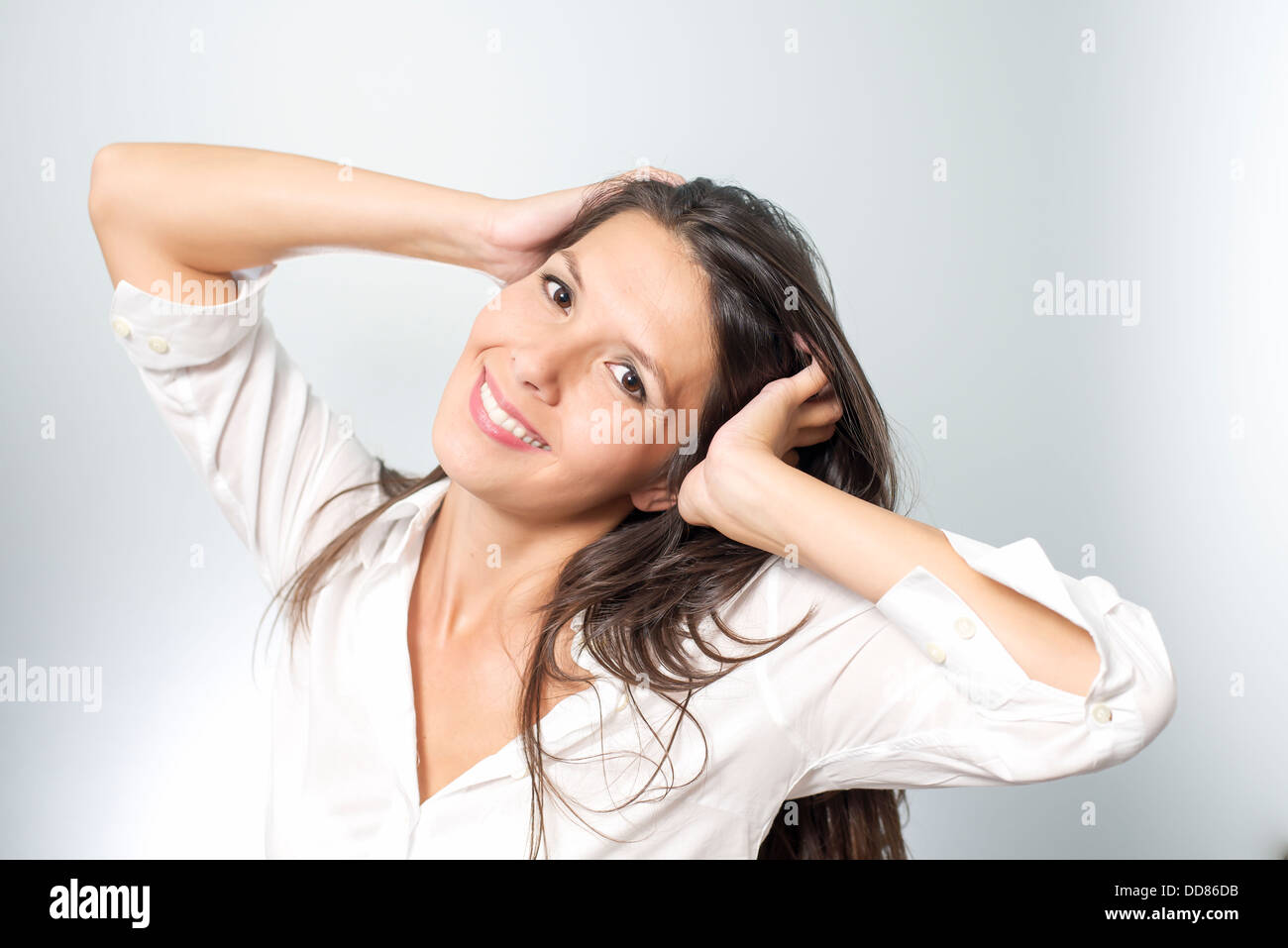 portrait of attractive brunette woman tilting her head to one side Stock Photo - Alamy