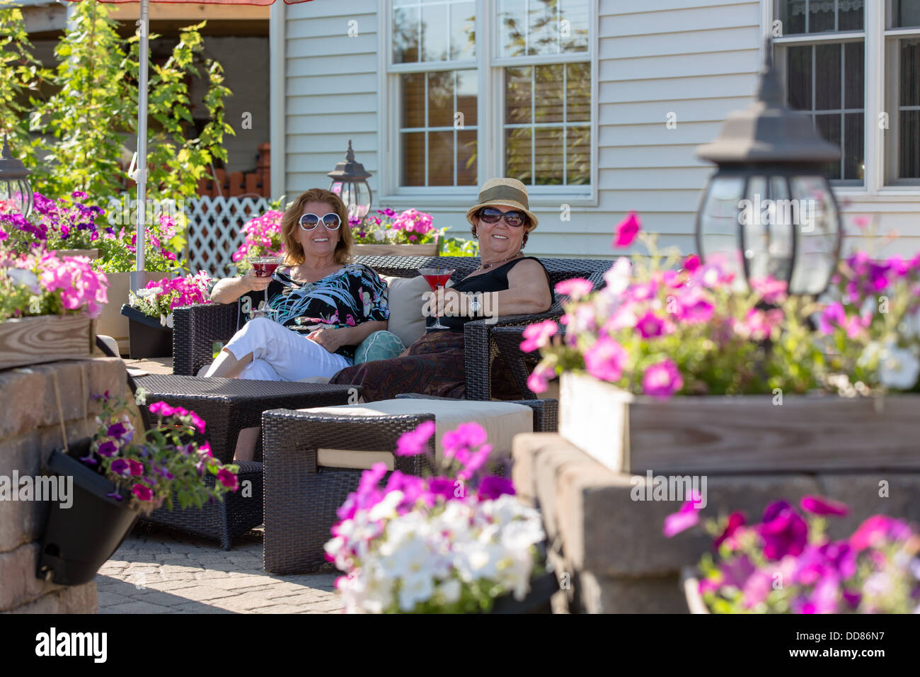 Beautiful woman sitting patio table hi-res stock photography and images ...