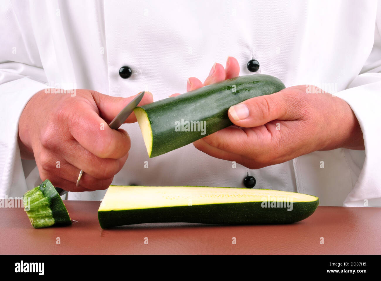 female chef cut one zucchini with a kitchen knife Stock Photo - Alamy