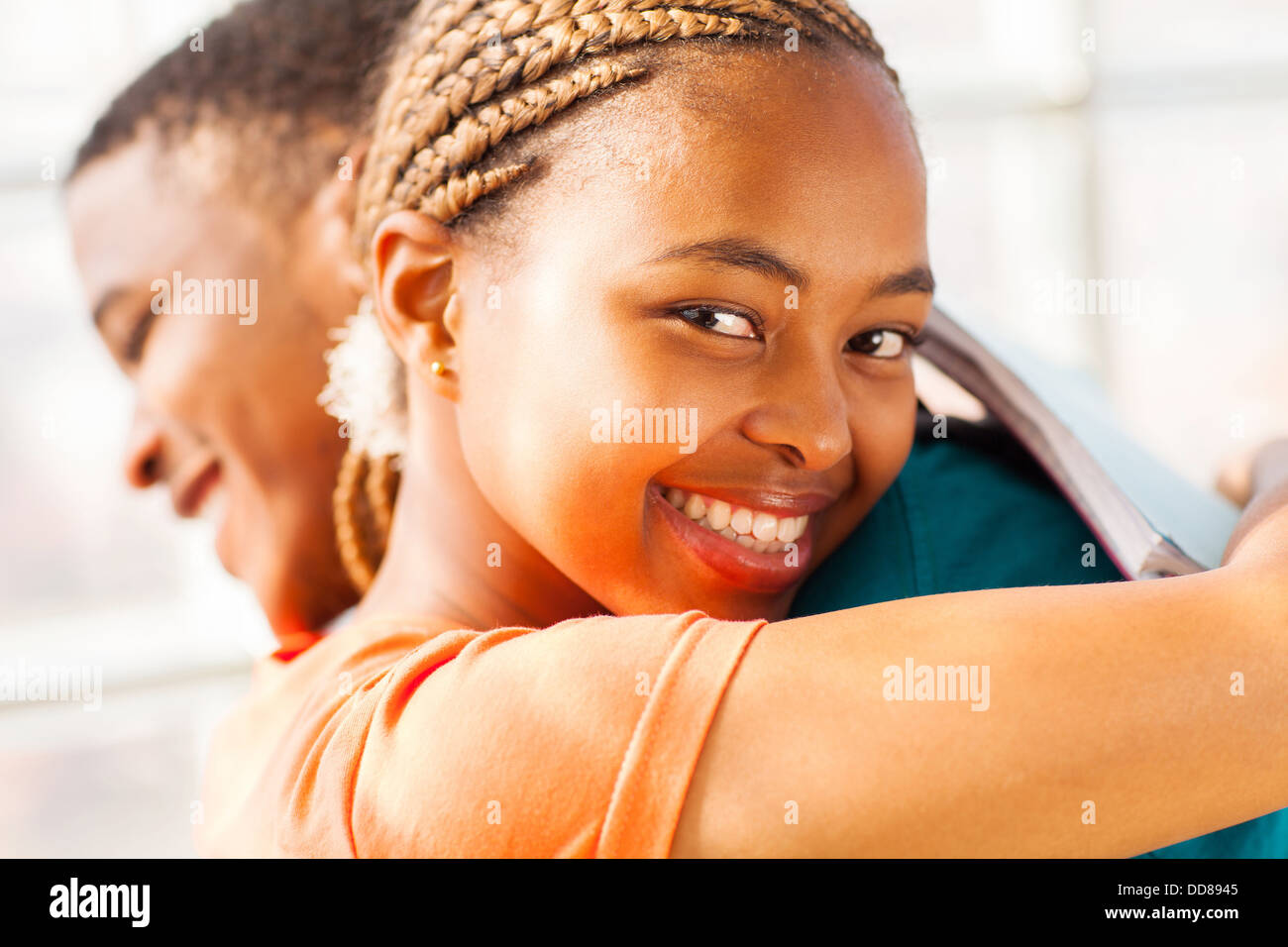 beautiful young African girl hugging her boyfriend Stock Photo - Alamy