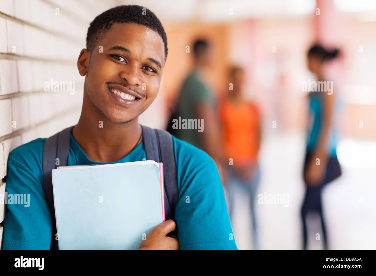 portrait of afro American university student holding books Stock Photo ...