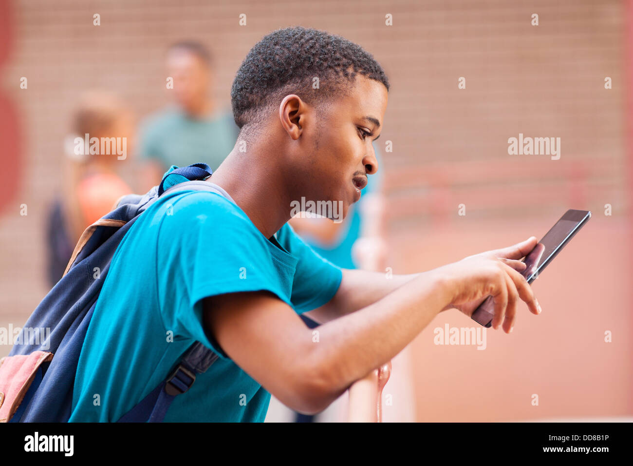 cute male African college student using tablet computer Stock Photo - Alamy