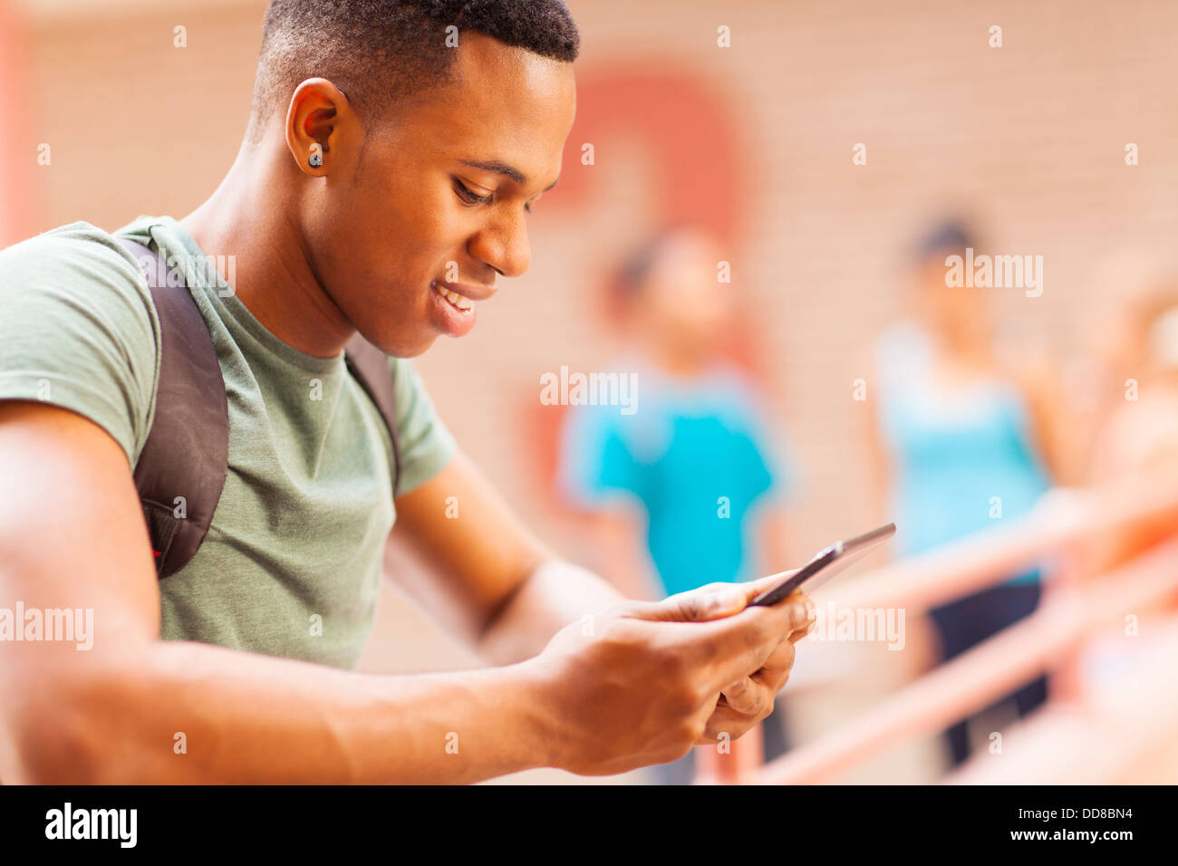 happy male African university student using tablet computer Stock Photo ...