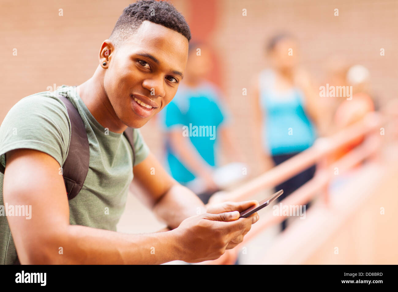 portrait of cute African college student with tablet computer on campus ...