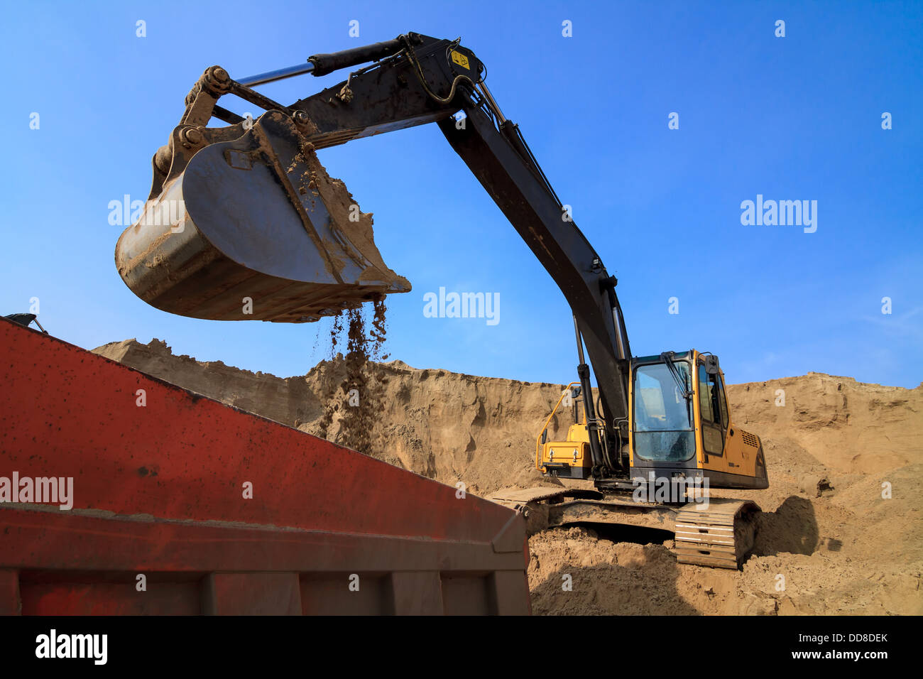 Excavator Loading Dumper Truck at Construction Site Stock Photo - Alamy