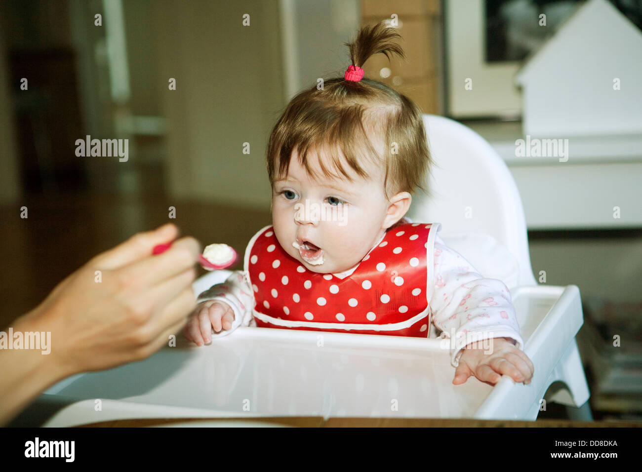Baby Girl eating Stock Photo - Alamy