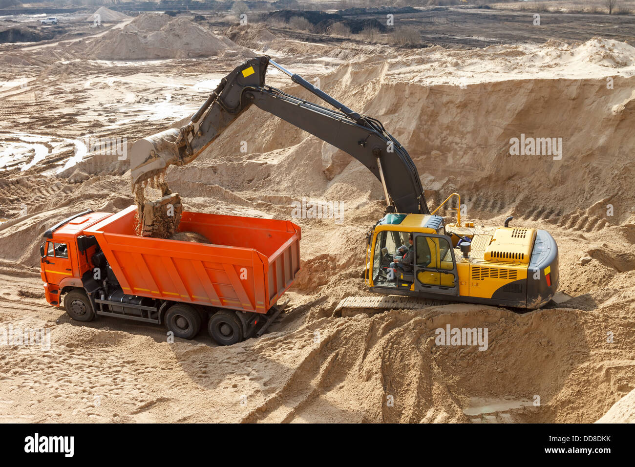 Excavator Loading Dumper Truck at Construction Site Stock Photo - Alamy